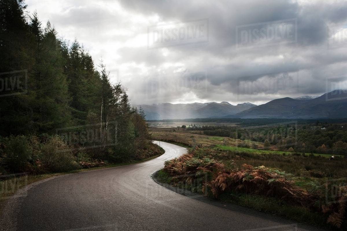 Winding road through mountains, Scotland, UK - Stock Photo - Dissolve