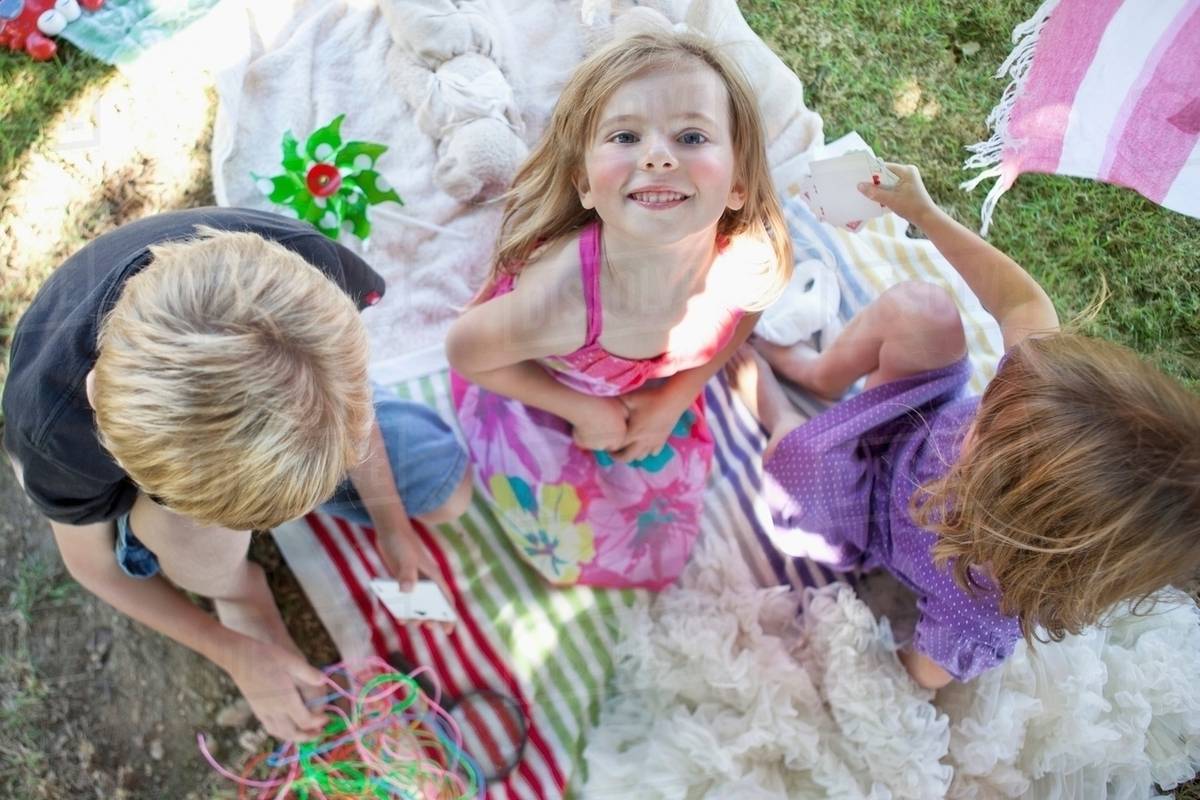 Children playing on blanket in backyard - Royalty-free Stock Photo ...