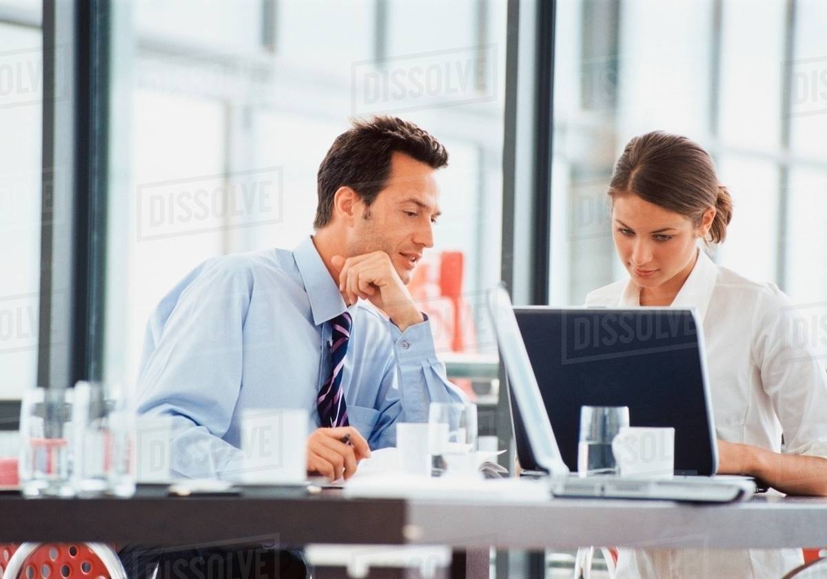 Business people working at desk - Stock Photo - Dissolve