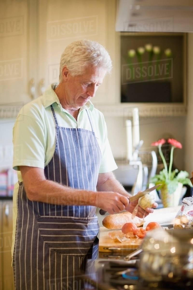 Older man cooking in kitchen - Stock Photo - Dissolve