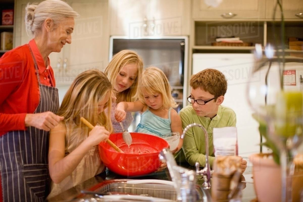 Family cooking together in kitchen - Royalty-free Stock Photo | Dissolve