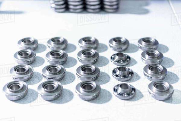 Valve rotators on assembly line in automotive parts factory - Stock ...