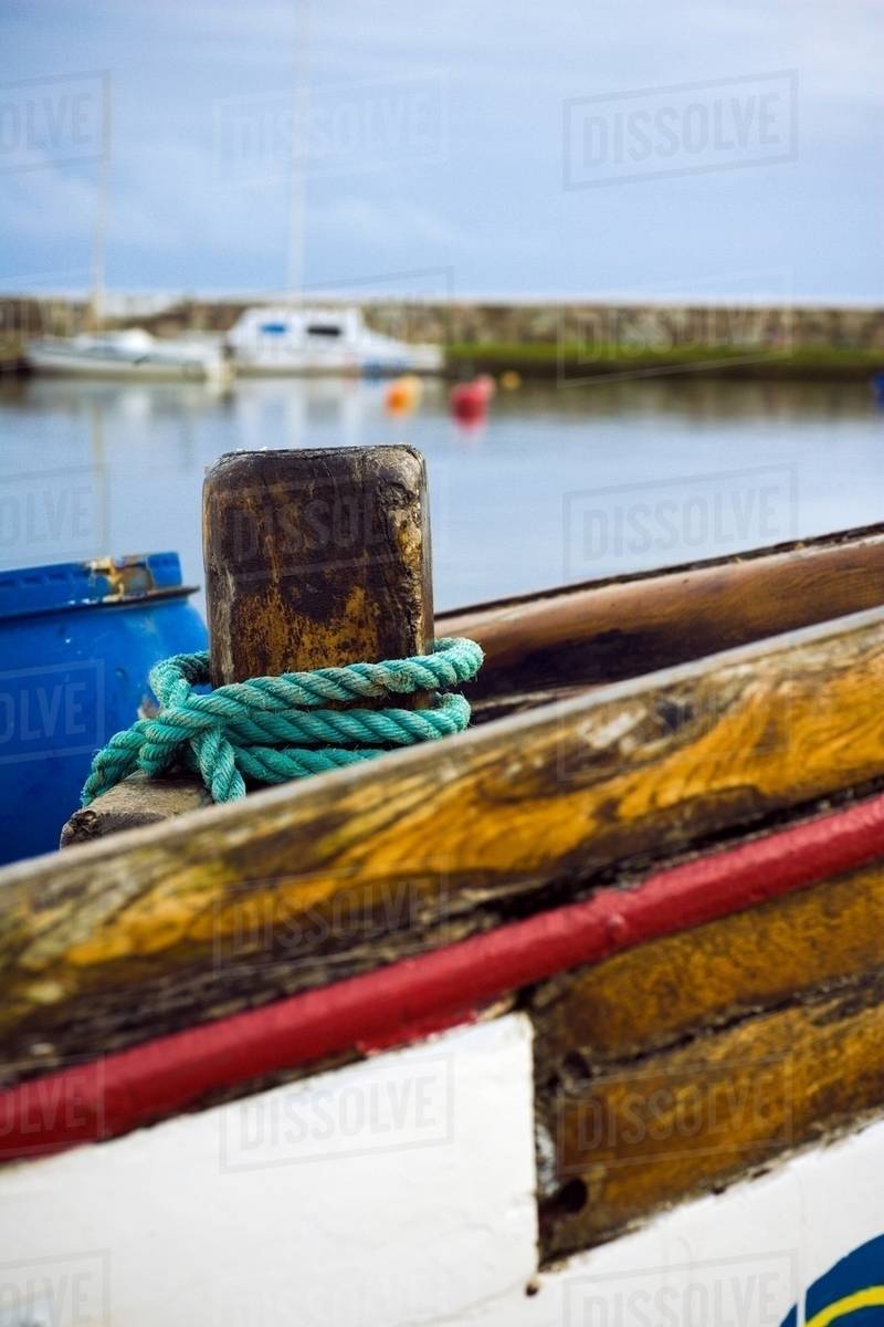 Rope wrapped around wooden dock post - Royalty-free Stock Photo | Dissolve