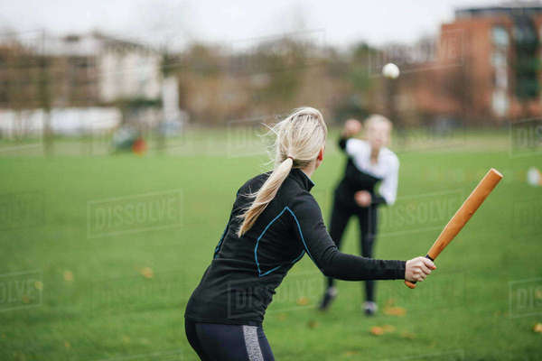 Rear view of female rounders player playing rounders match - Stock ...