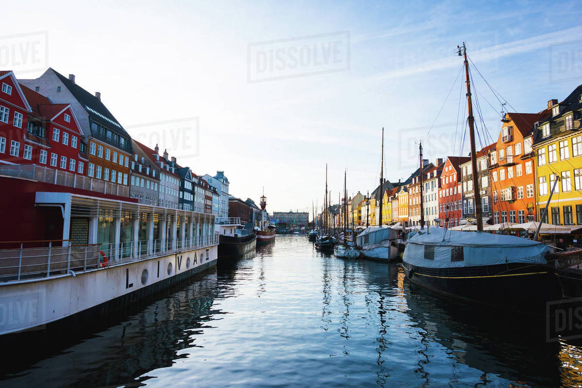 Traditional townhouses and moored boats on canal waterfront, Copenhagen ...