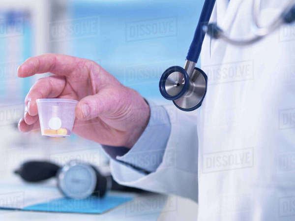 Doctor passing a cup of drugs to a patient - Royalty-free Stock Photo ...