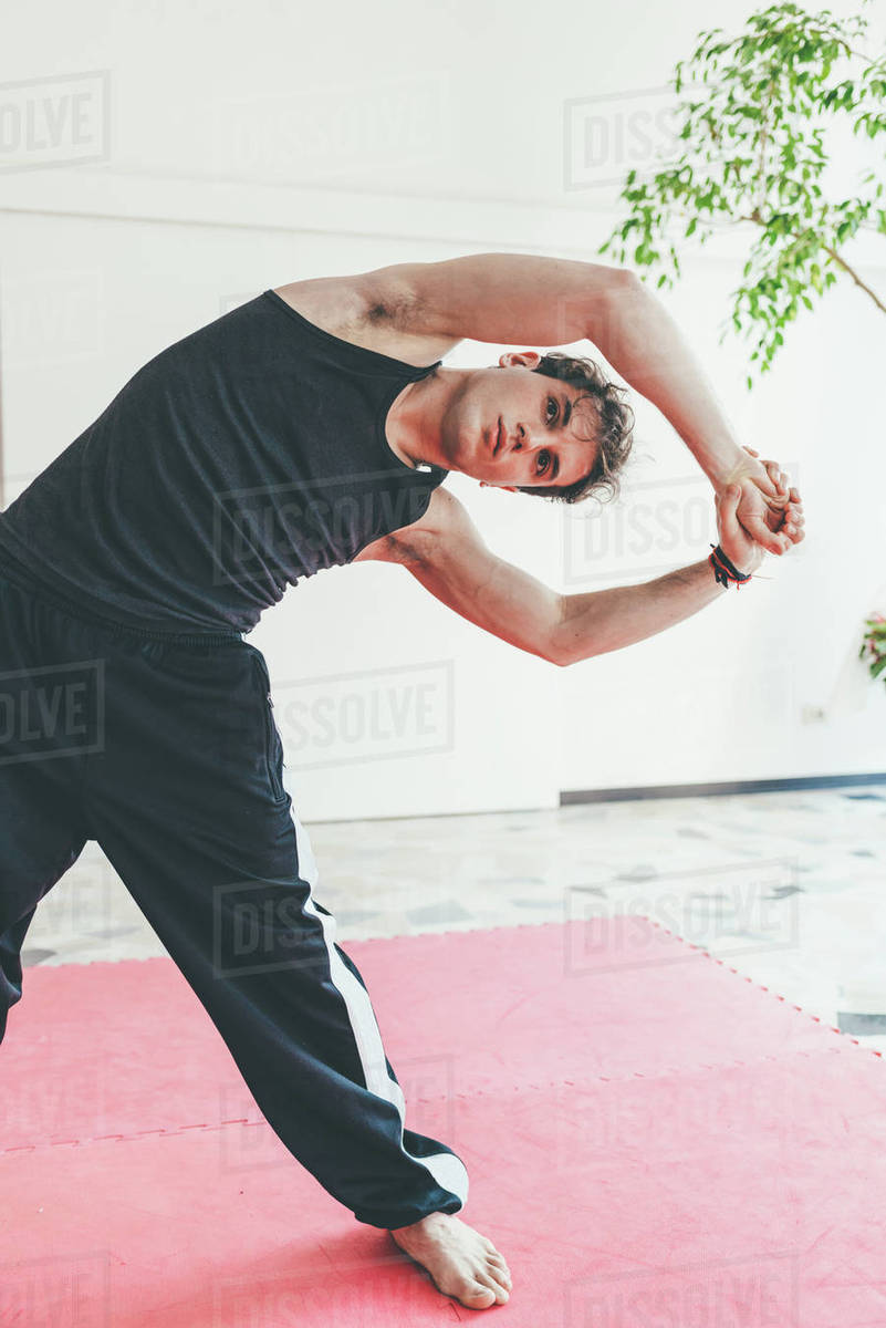 Man bending over sideways doing stretching exercises - Royalty-free ...