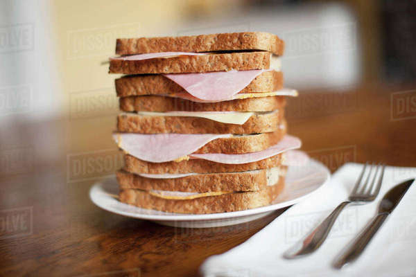 Stack of ham sandwiches on plate - Royalty-free Stock Photo | Dissolve