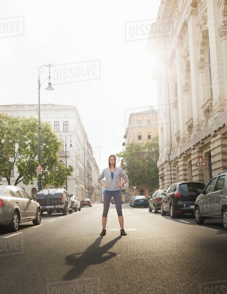 Woman standing on city street - Stock Photo - Dissolve