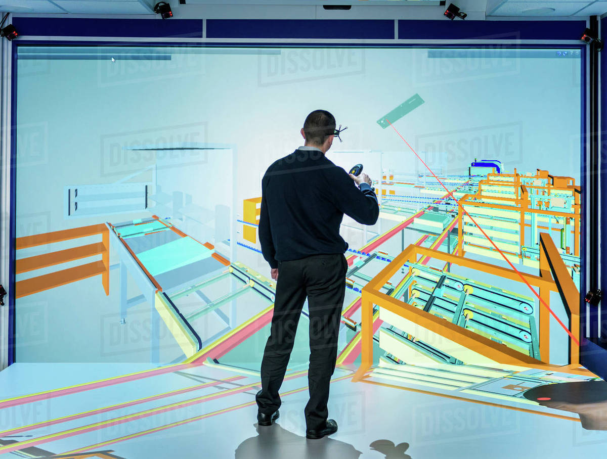 Engineer inspecting factory layout in 3D in virtual reality suite ...