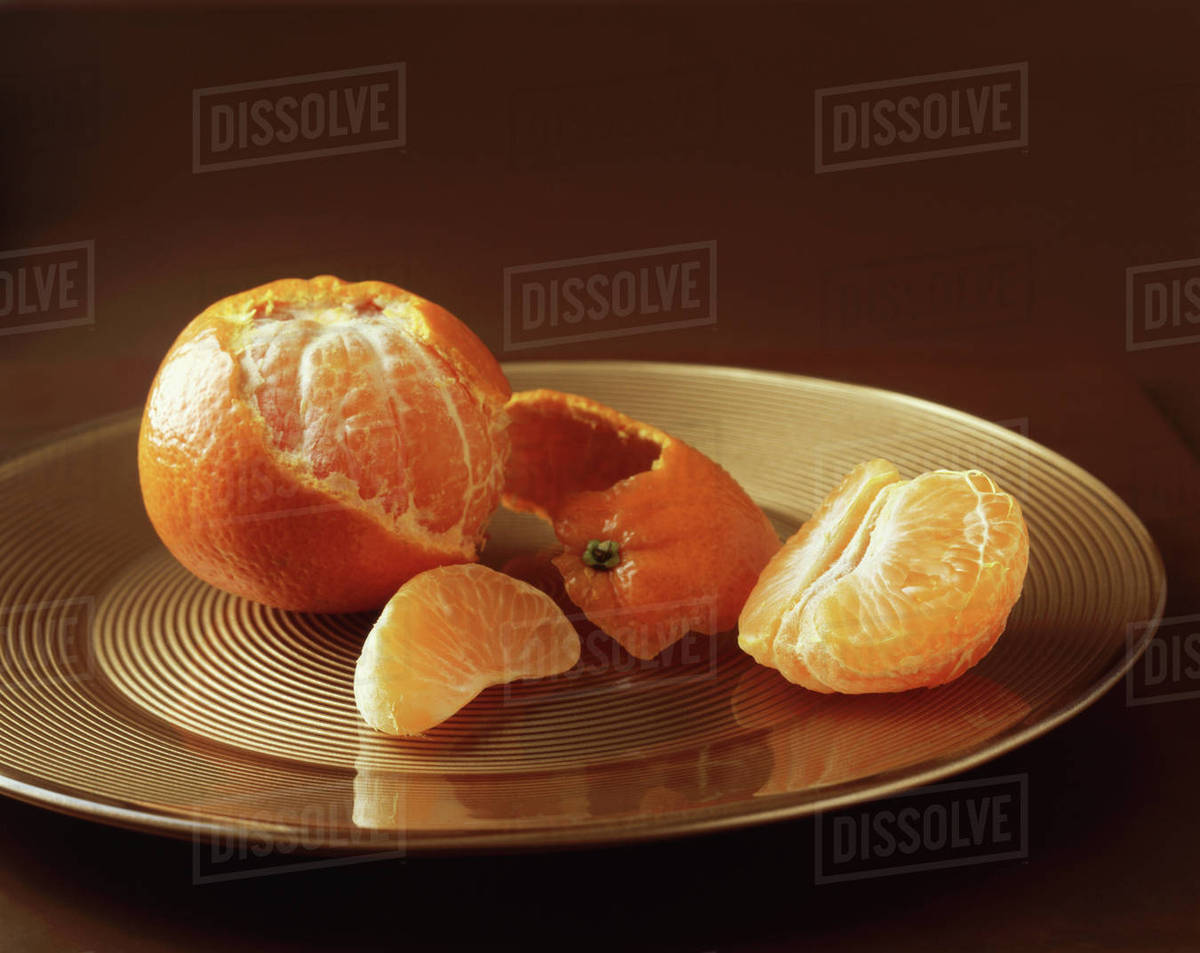 Food, fruit, clementine half peeled on golden plate - Stock Photo ...