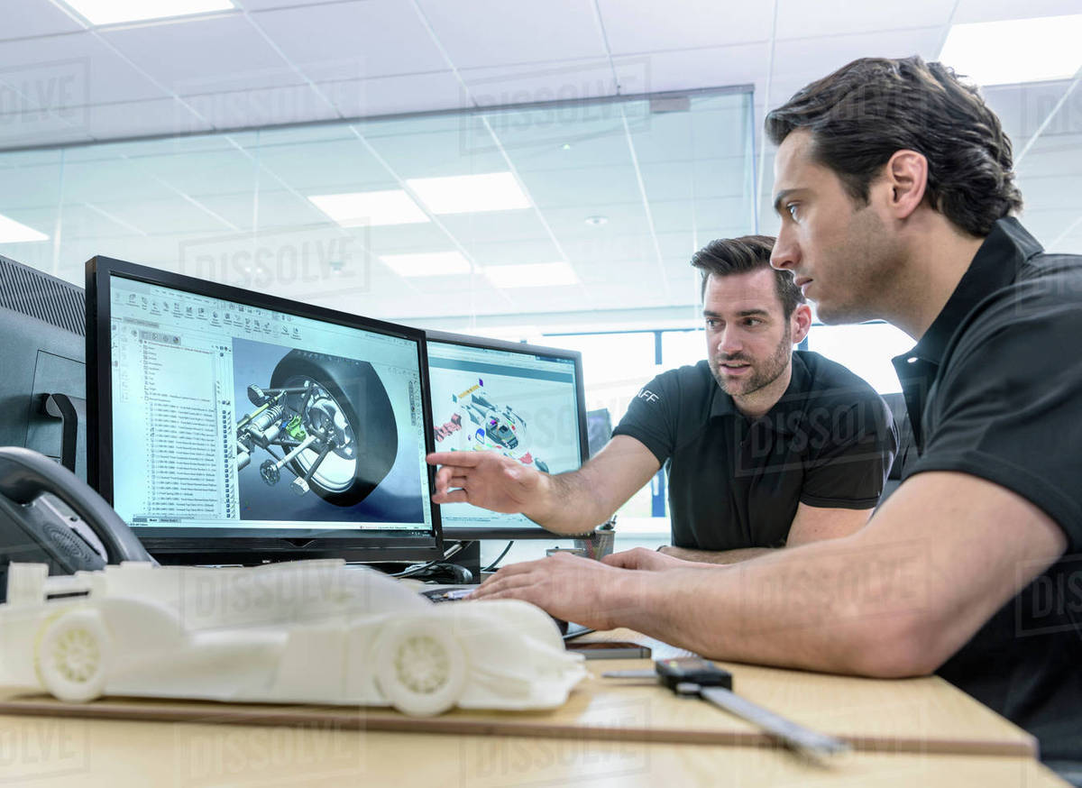 Engineers work with CAD design imagery in racing car factory - Stock ...