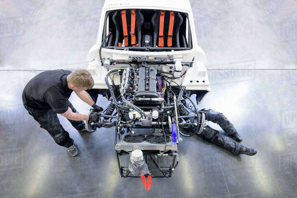 Engineers constructing racing car in racing car factory - Stock Photo ...