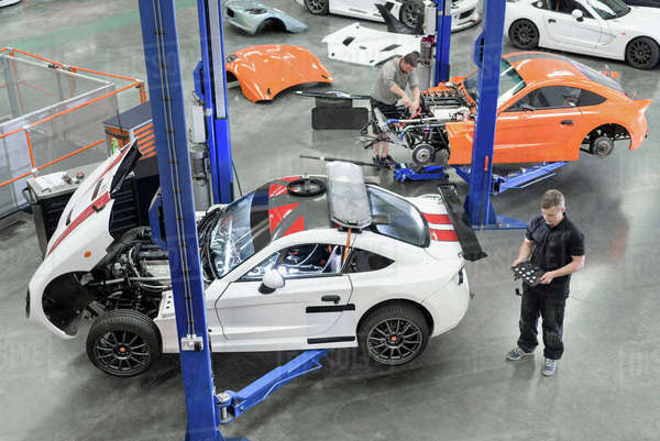 Engineer repairing racing cars in racing car factory - Stock Photo ...