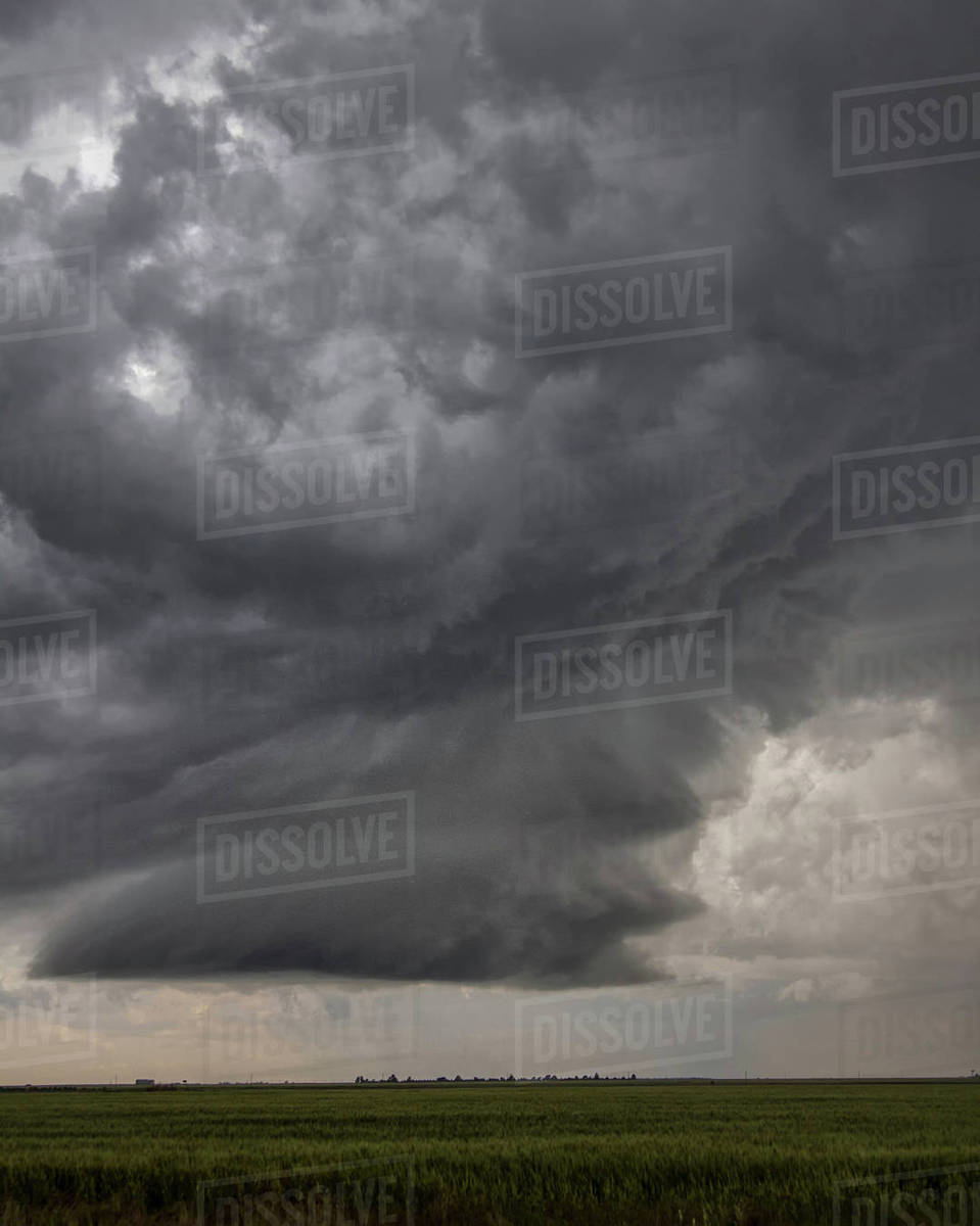 Rotating supercell clouds over field - Royalty-free Stock Photo | Dissolve