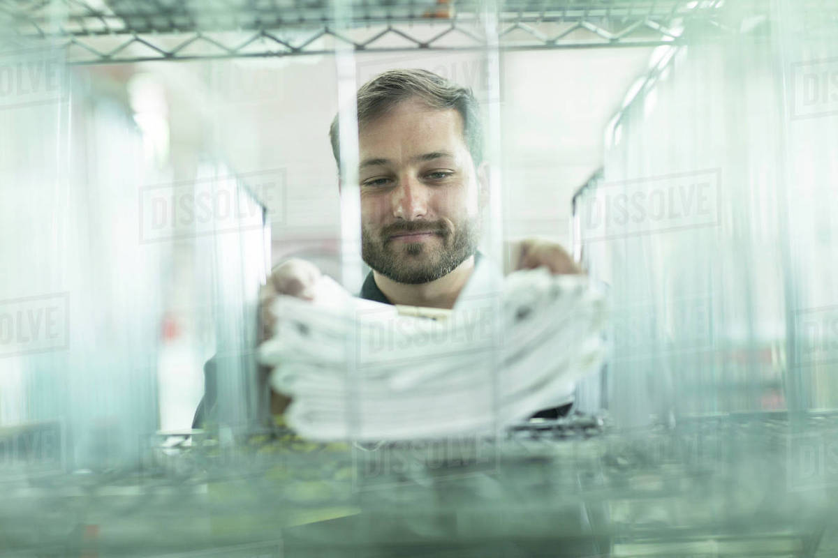 Man stacking roll cage - Royalty-free Stock Photo | Dissolve