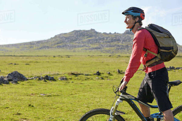 Side view of cyclist cycling on hillside - Royalty-free Stock Photo ...