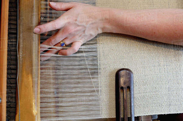 Hands of young woman using loom - Royalty-free Stock Photo | Dissolve