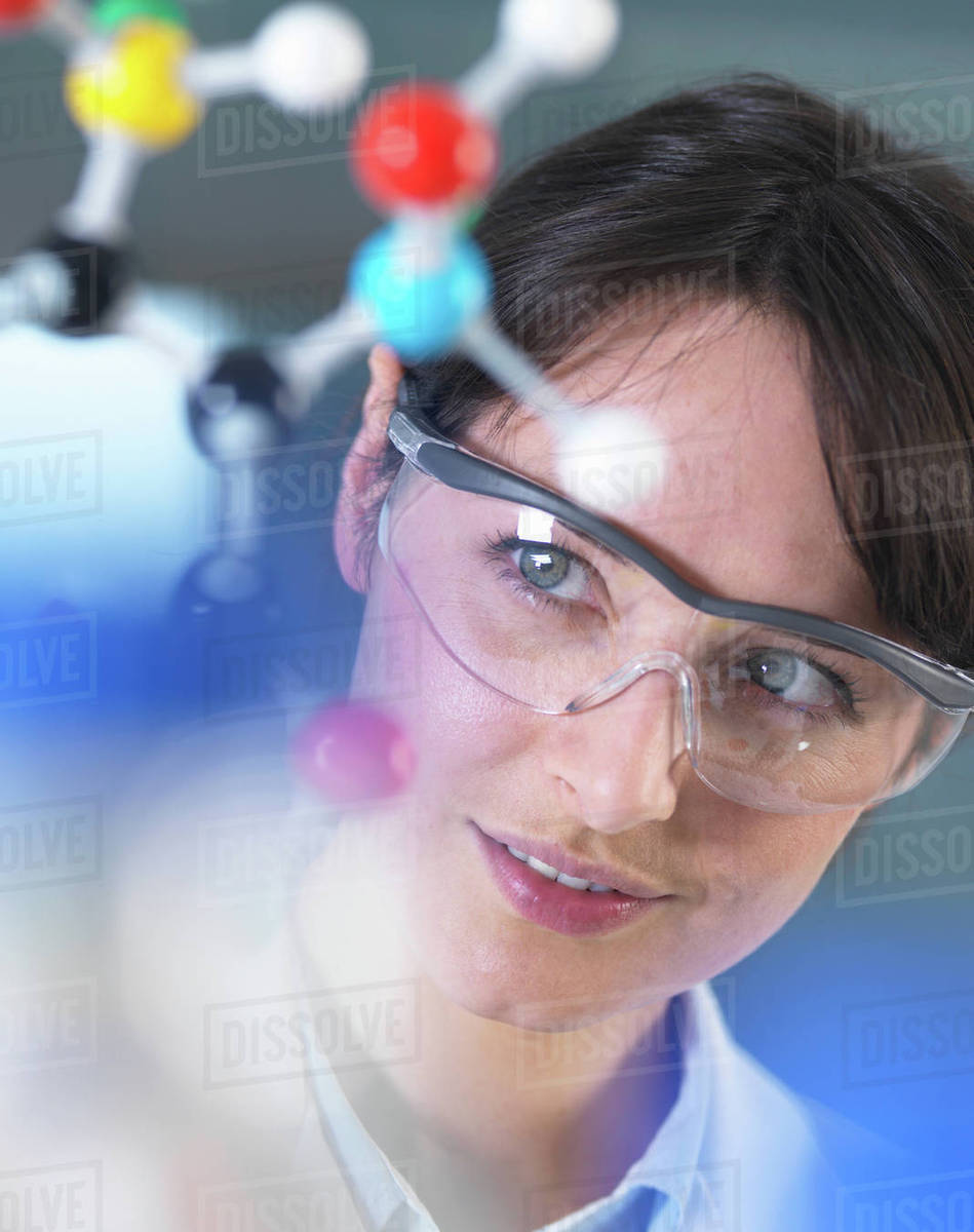 Scientist analysing molecular model in laboratory - Royalty-free Stock ...