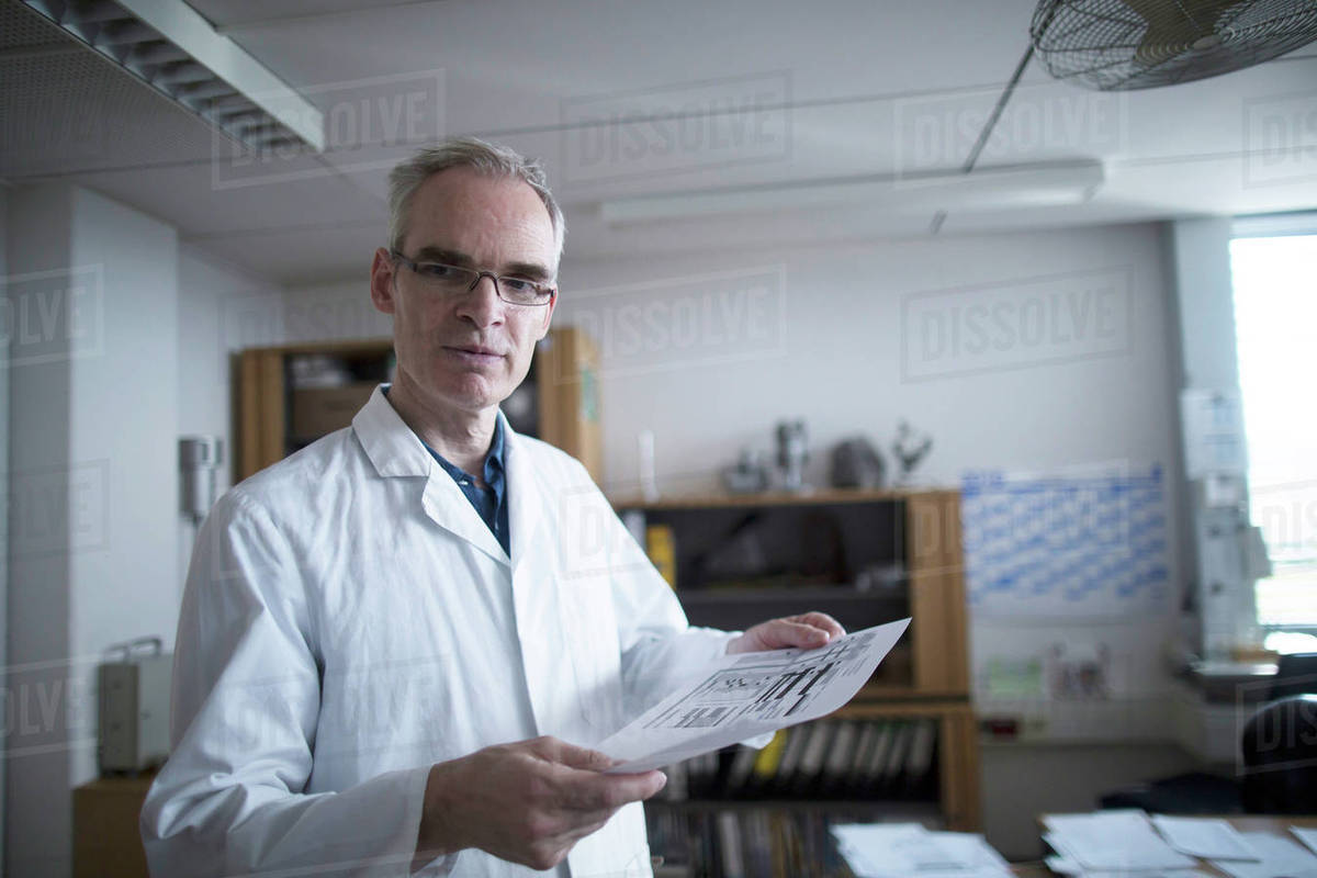 Portrait of male meteorologist holding data at weather station ...