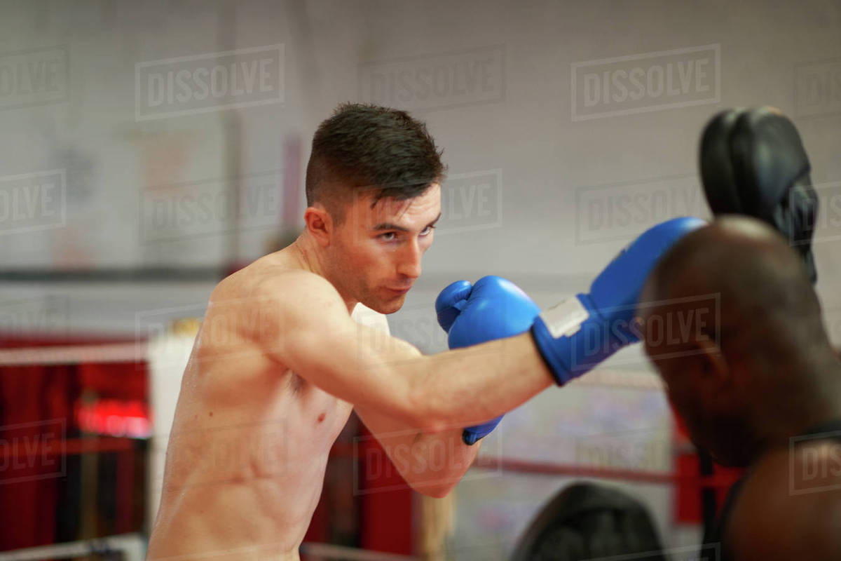 Boxer working out with coach in boxing ring - Royalty-free Stock Photo ...