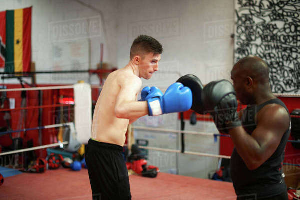Boxer working out with coach in boxing ring - Royalty-free Stock Photo ...