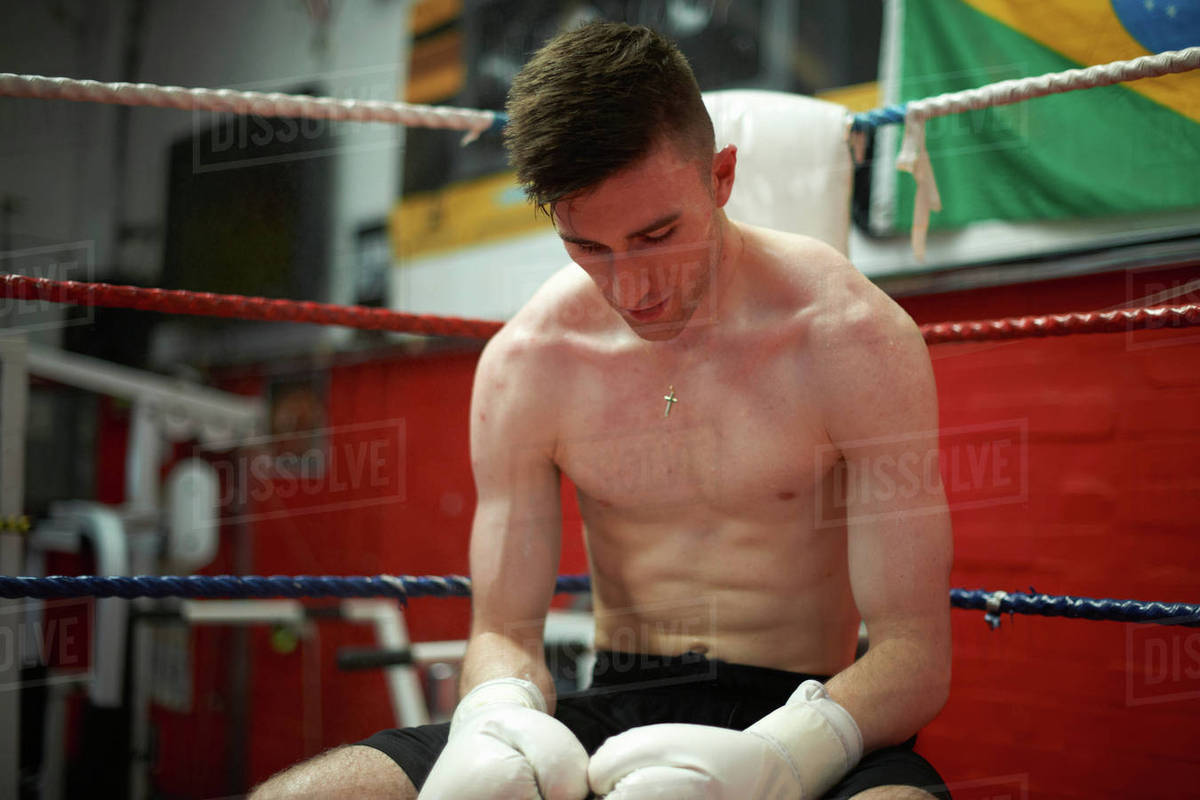 Boxer sitting in corner of boxing ring, exhausted - Royalty-free Stock ...