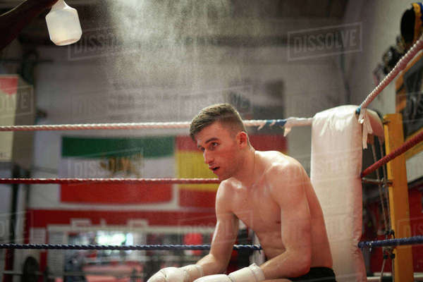 Boxer sitting in corner of boxing ring, exhausted - Royalty-free Stock ...