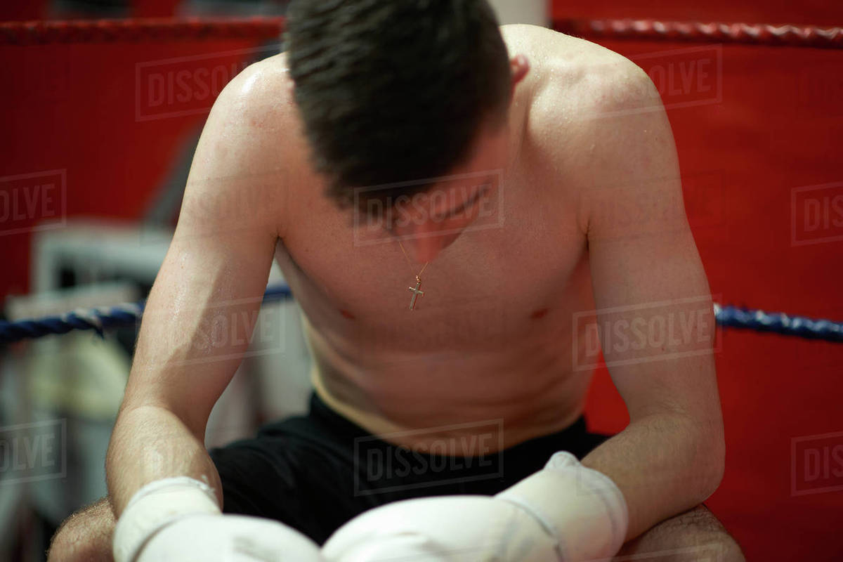 Boxer sitting in corner of boxing ring, exhausted - Royalty-free Stock ...