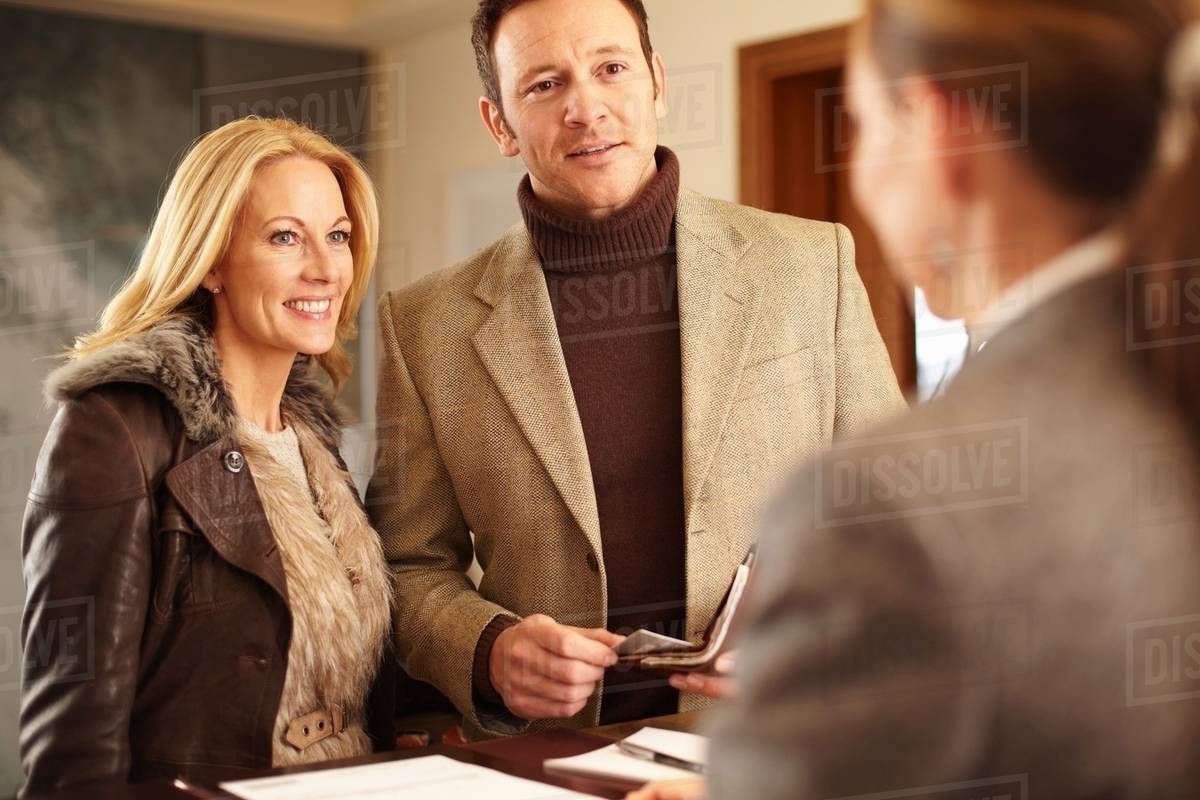 Couple checking in to hotel - Royalty-free Stock Photo | Dissolve