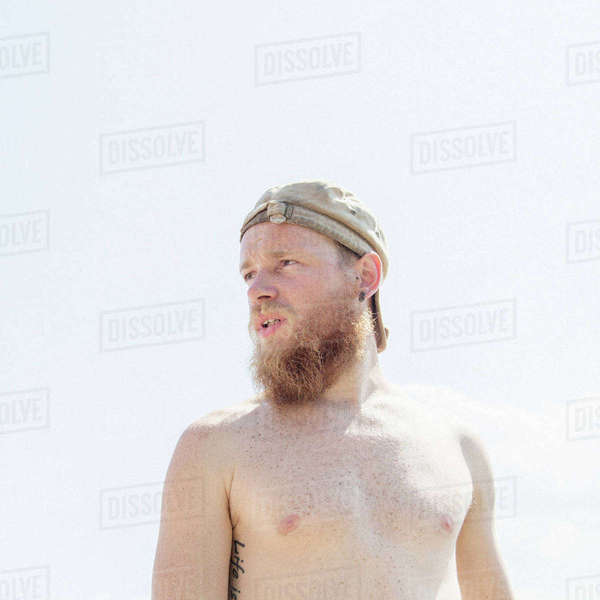 Bearded bare chested man looking away - Stock Photo - Dissolve