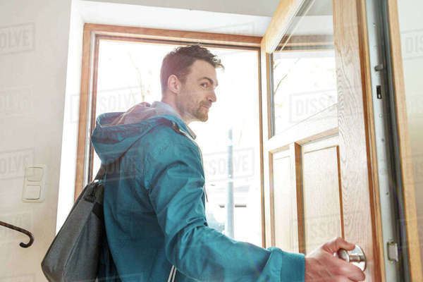 Man leaving front door of house - Royalty-free Stock Photo | Dissolve