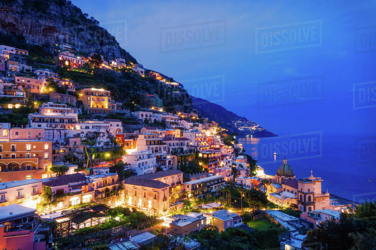 Cliff side buildings illuminated at night, Positano, Amalfi Coast ...