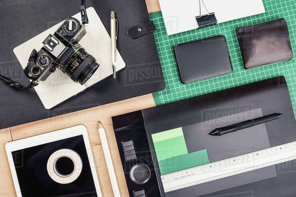 Overhead view of retro camera, notebook, diary, external hard drive ...