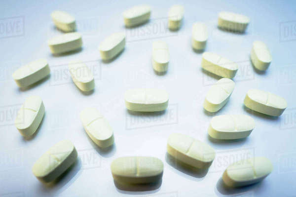 White oval pills - Stock Photo - Dissolve