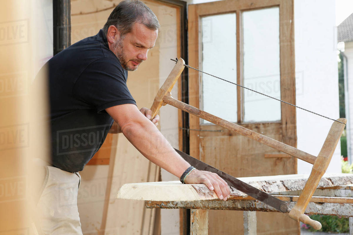 Man using frame saw - Royalty-free Stock Photo | Dissolve