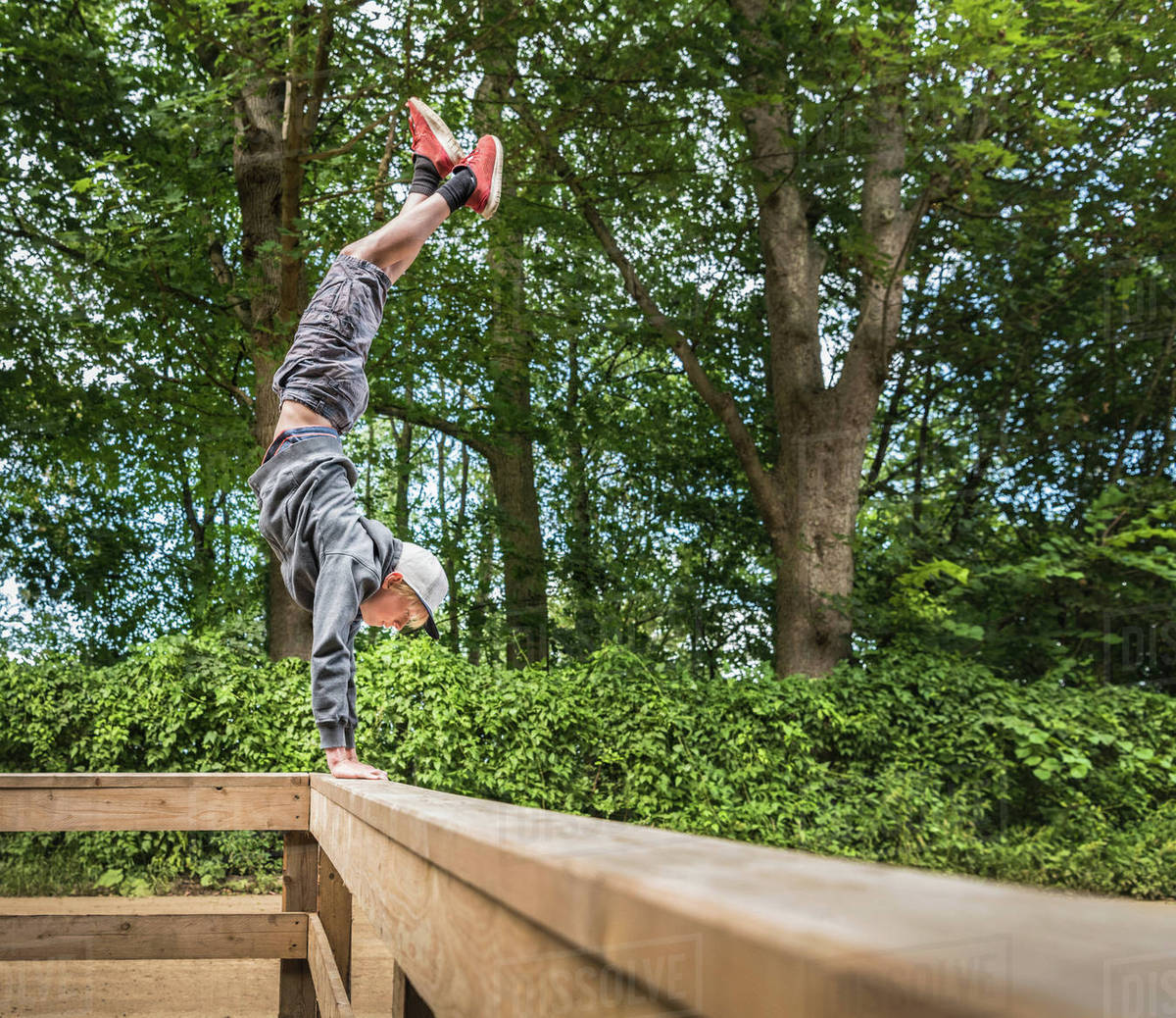 Boy doing handstand on handrail - Royalty-free Stock Photo | Dissolve