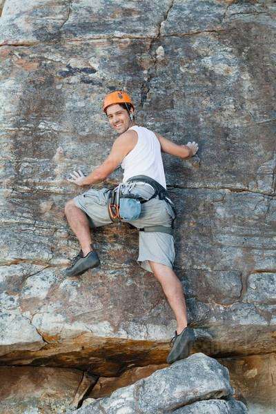 Climber scaling steep rock face - Royalty-free Stock Photo | Dissolve