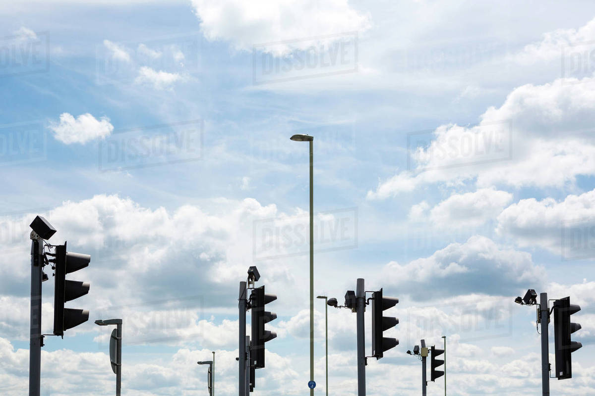 Traffic lights amongst street lamps and road signs, Swindon, Wiltshire ...