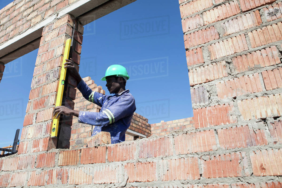 Builder working on construction site - Stock Photo - Dissolve
