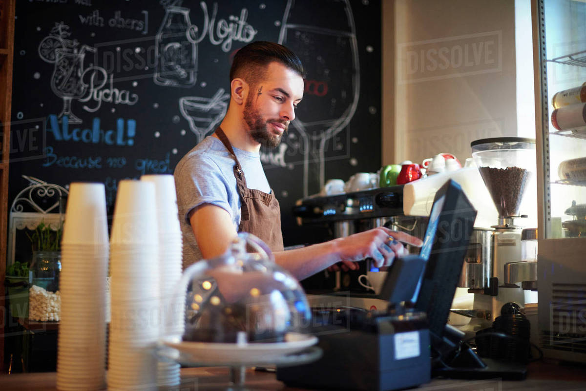 Barista using cash register - Royalty-free Stock Photo | Dissolve