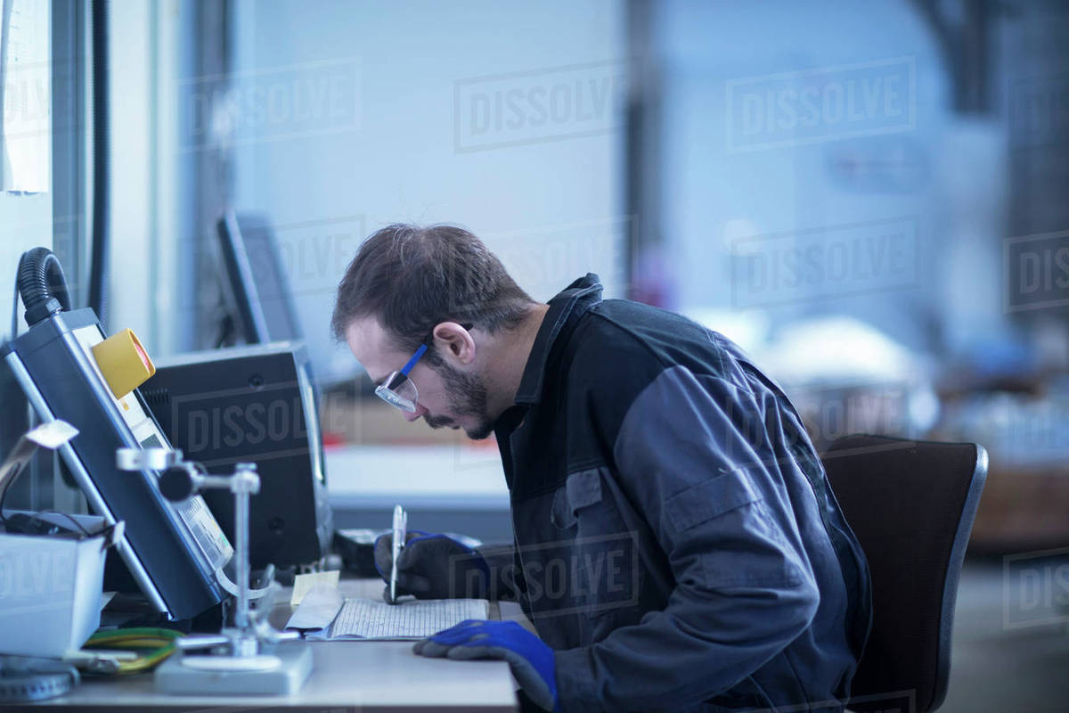 Engineer at desk drawing - Royalty-free Stock Photo | Dissolve