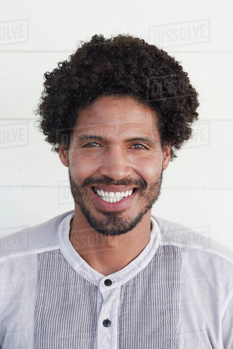 Portrait of man looking at camera smiling - Stock Photo - Dissolve