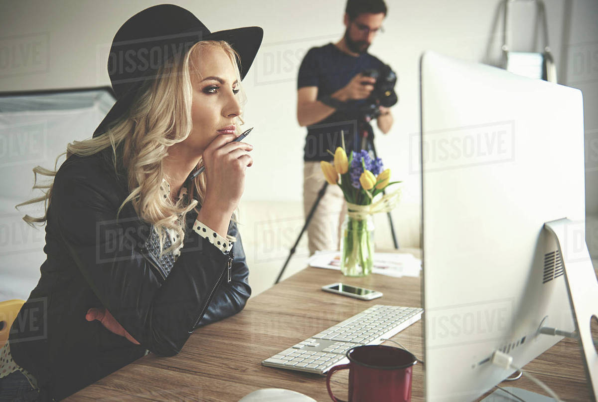 Photographer looking at photography studio computer - Royalty-free ...