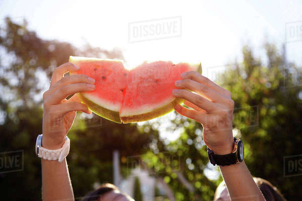 Teenage girls holding up watermelon in street - Royalty-free Stock ...