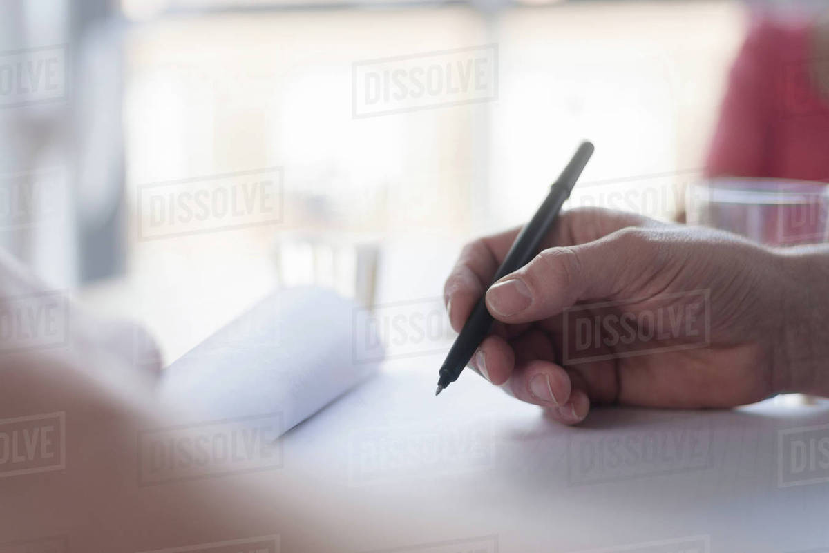 Man writing notes on desk, close up of hand - Royalty-free Stock Photo ...