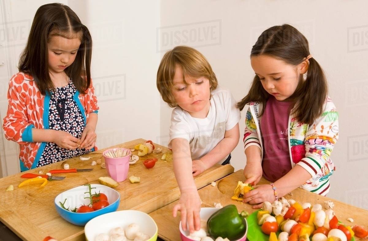 Children cooking together in kitchen - Royalty-free Stock Photo | Dissolve