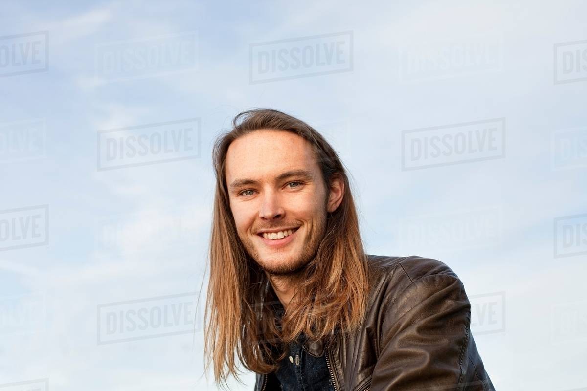 Smiling man standing outdoors - Stock Photo - Dissolve
