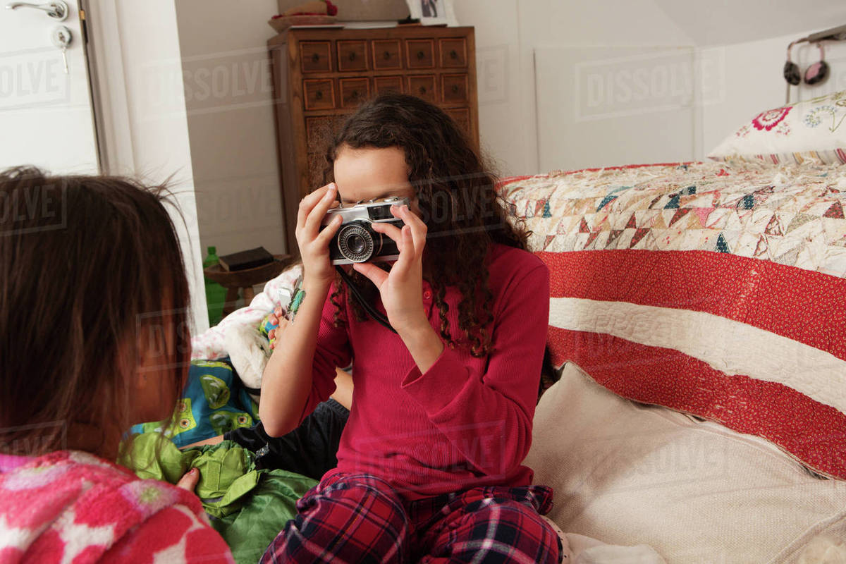 Girl photographing friend - Stock Photo - Dissolve