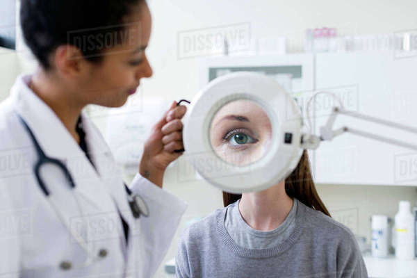 Doctor giving patient eye test - Stock Photo - Dissolve